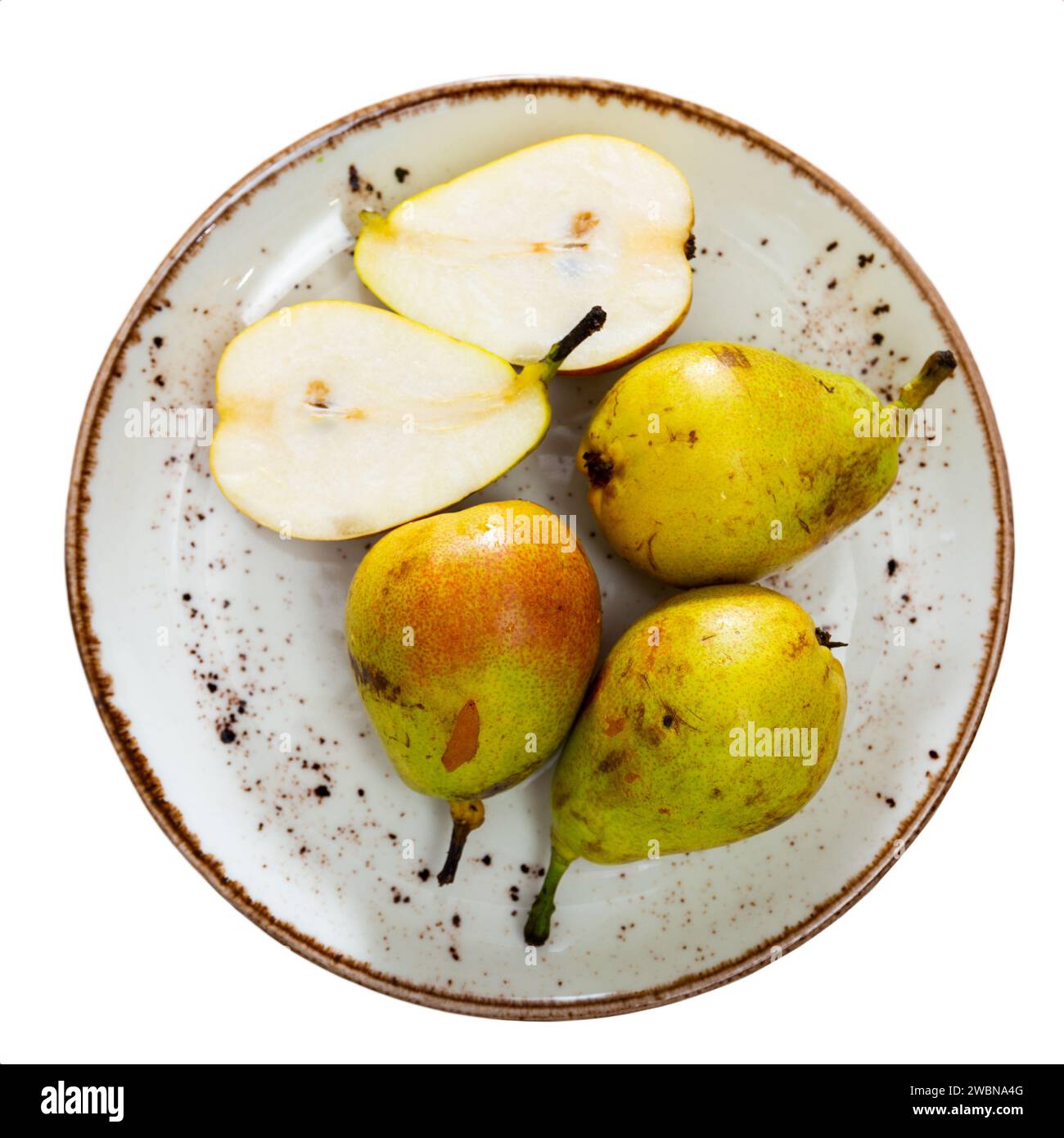 Juicy ripe pears, whole fruits and cut in half are on plate Stock Photo ...