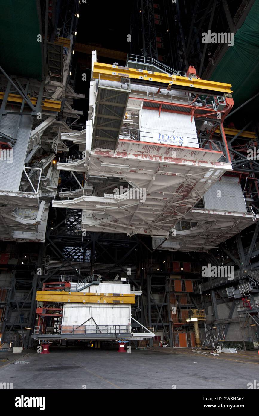 At NASA Kennedy Space Center, Florida, a crane lowers a space shuttle ...