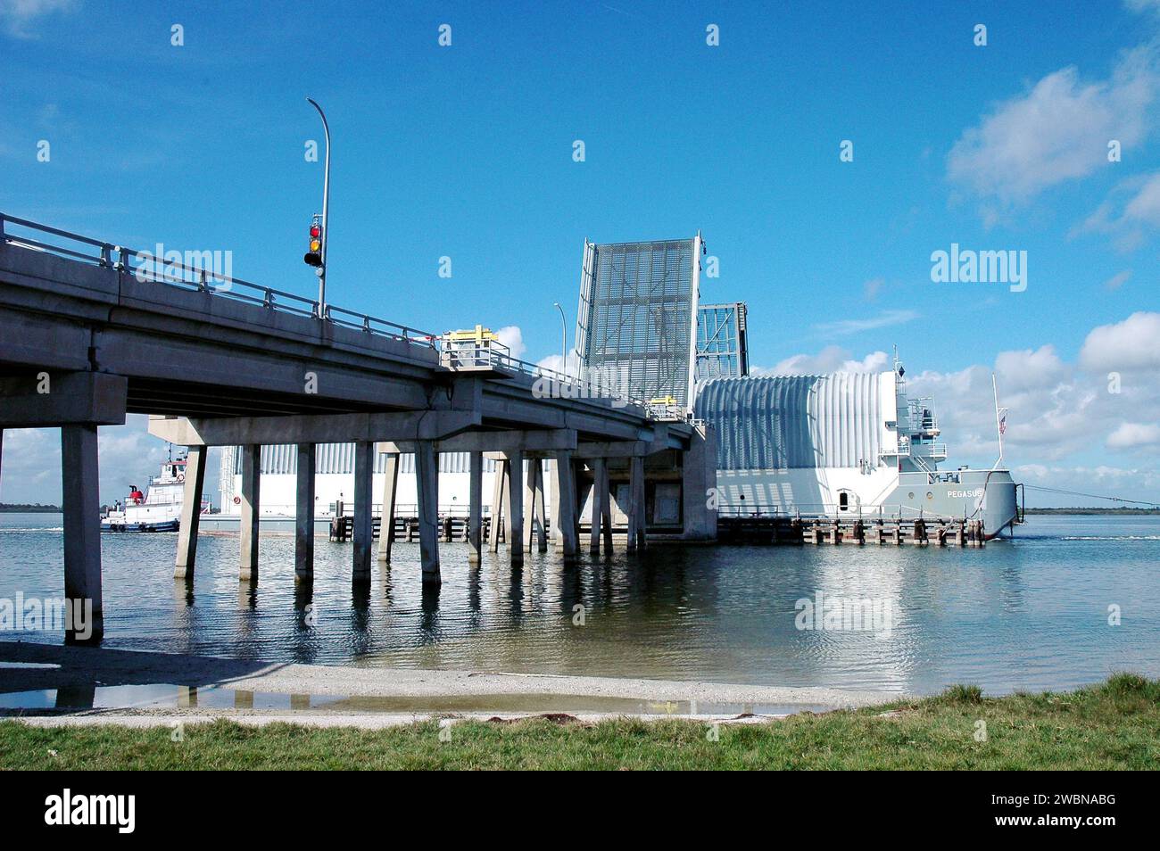 KENNEDY SPACE CENTER, FLA. - The tugboat towing the barge carrying the ...