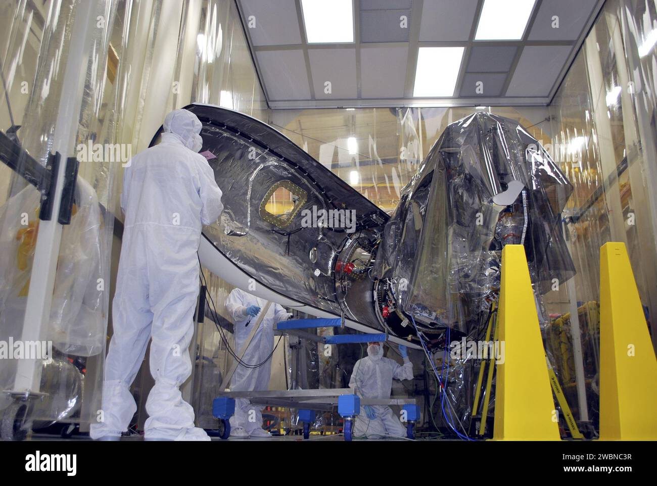 Engineers at Vandenberg Air Force Base install the payload fairing on ...