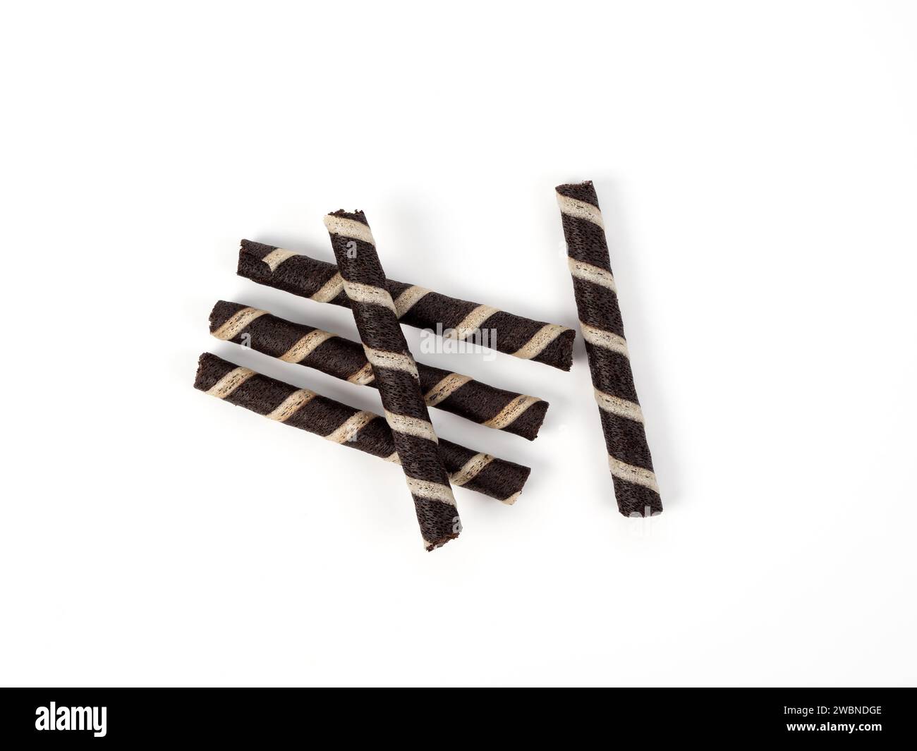 Crispy waffle rolls on a white background. Black and white wafer rolls ...