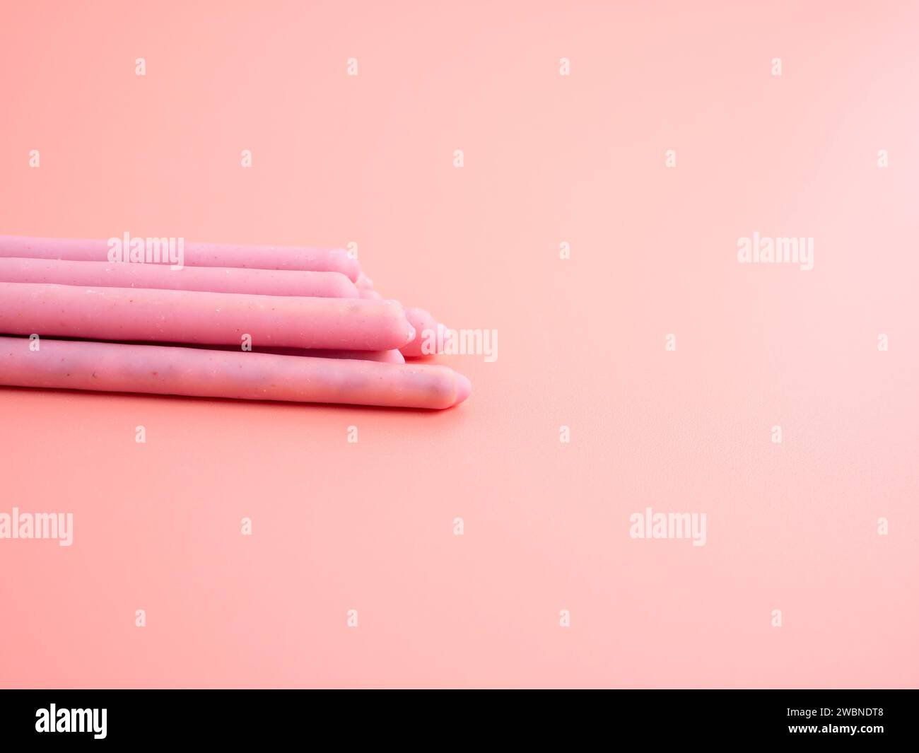 Crispy sticks in pink sugar glaze. Sticks in berry pink glaze on a pink ...