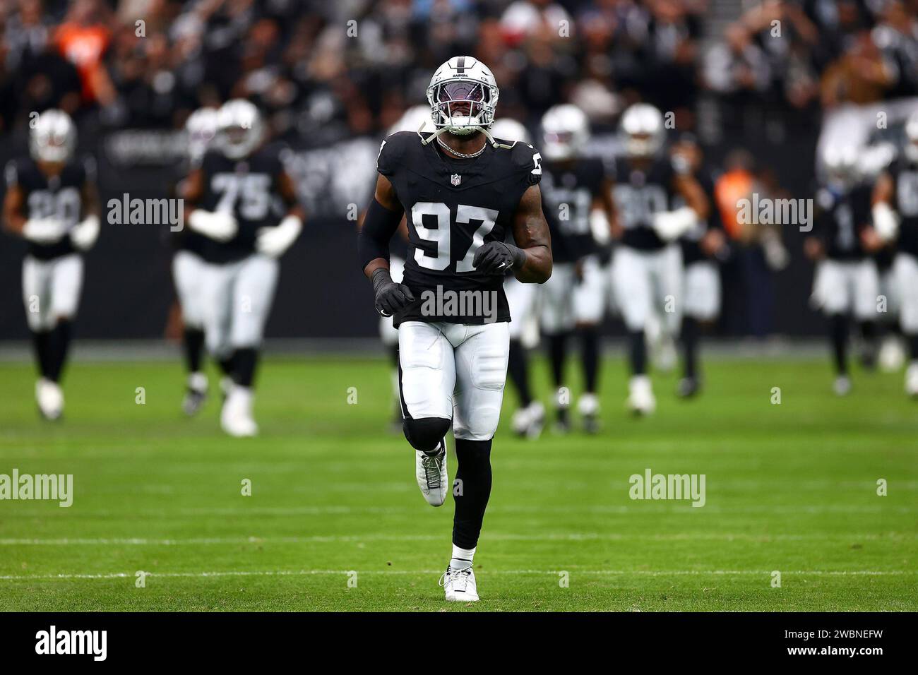Las Vegas Raiders defensive end Janarius Robinson warms up before an ...