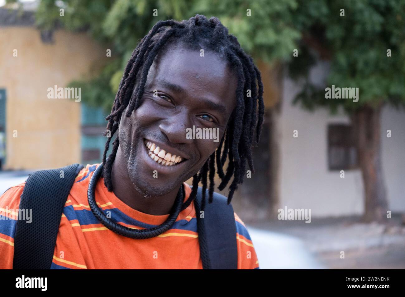 West Africa, Senegal, Saint Louis. A young man selling souvenirs to ...