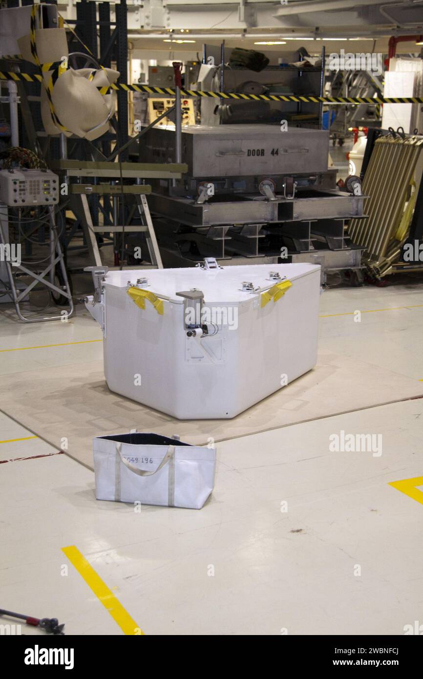 In Orbiter Processing Facility-1 at Kennedy Space Center, technicians ...