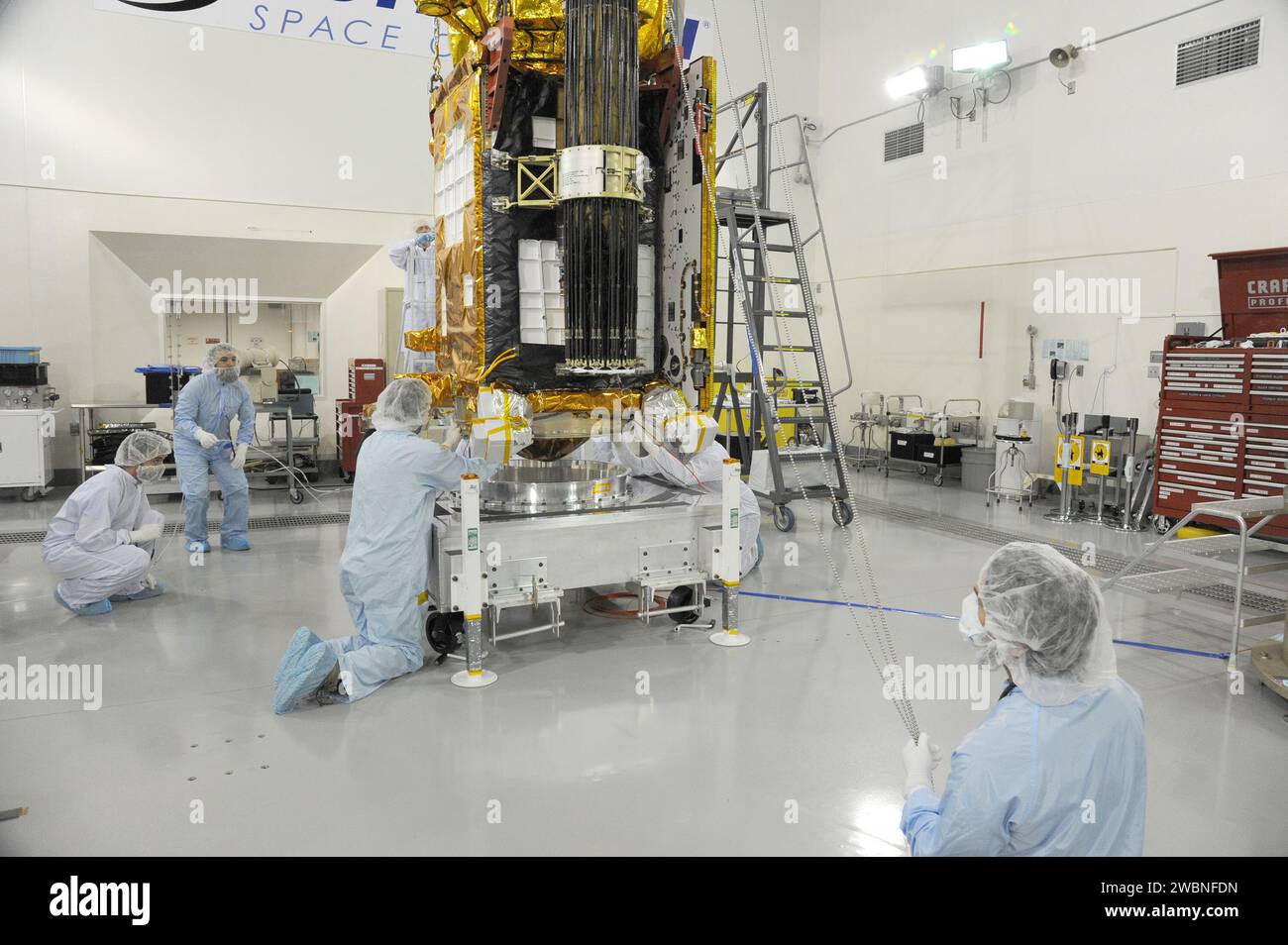 NASA technicians prepare the SMAP spacecraft for launch on a Delta II ...