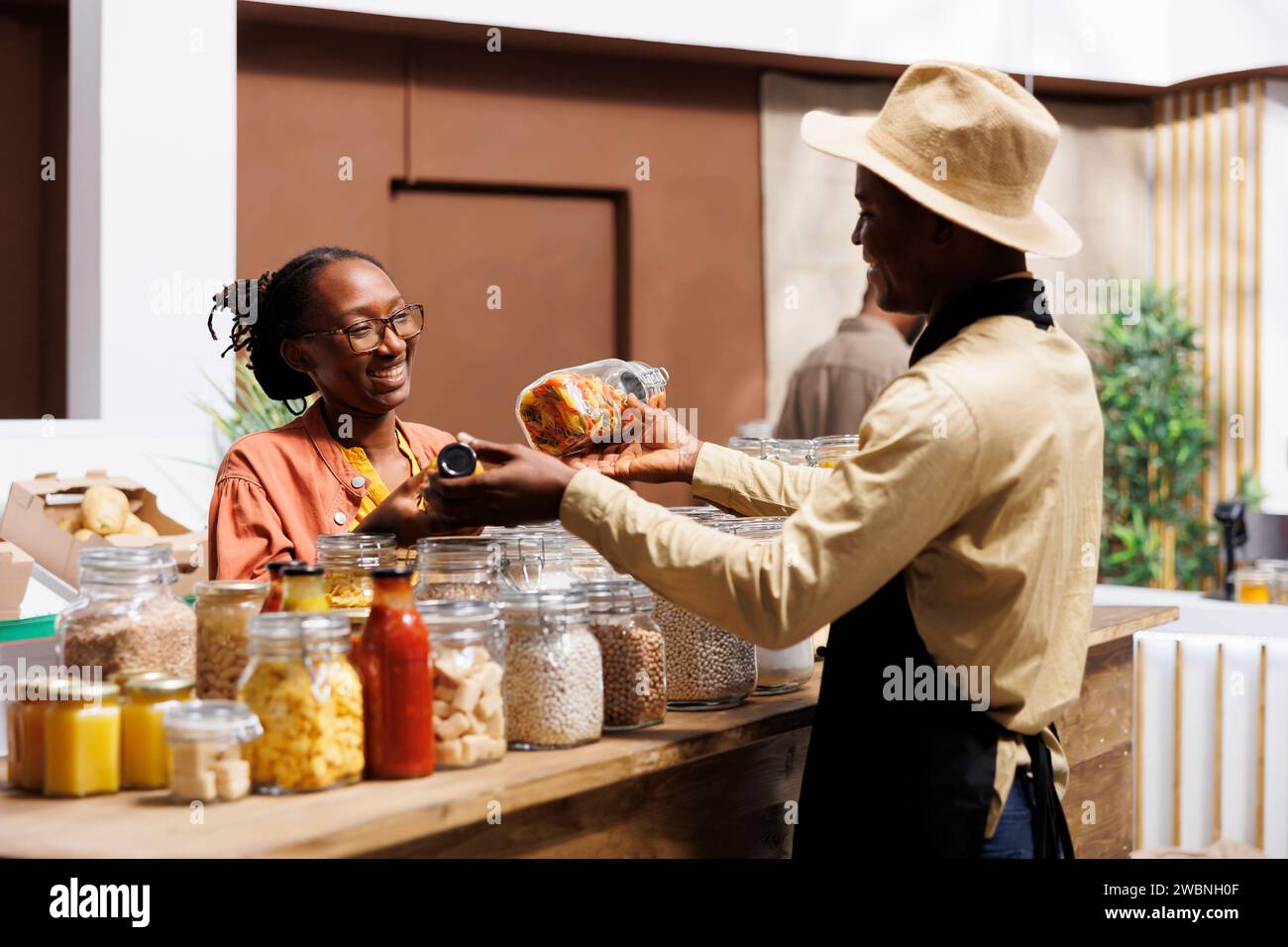 African American woman shops at a local supermarket, discussing organic ...