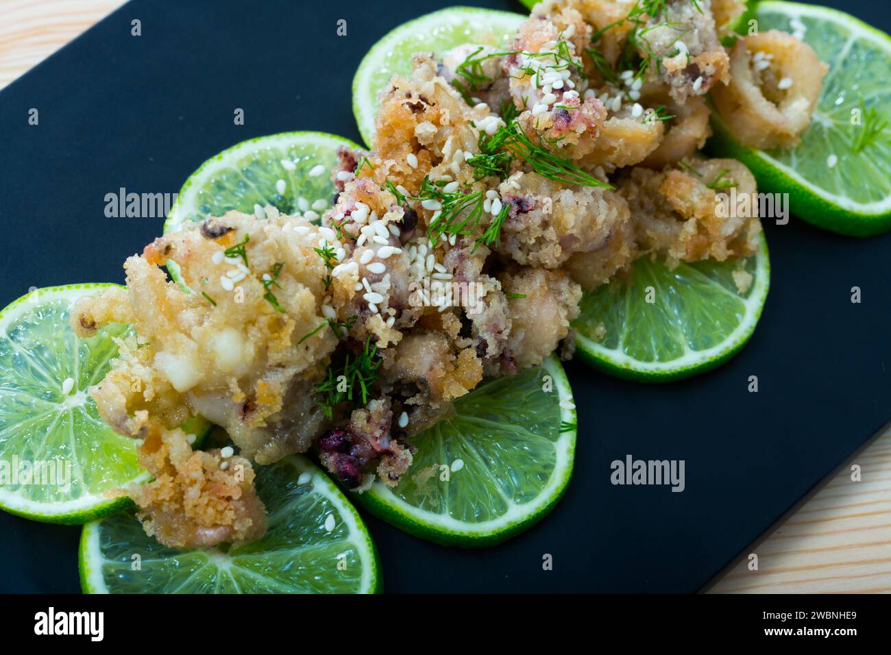 Battered calamari and cuttle with lime Stock Photo - Alamy