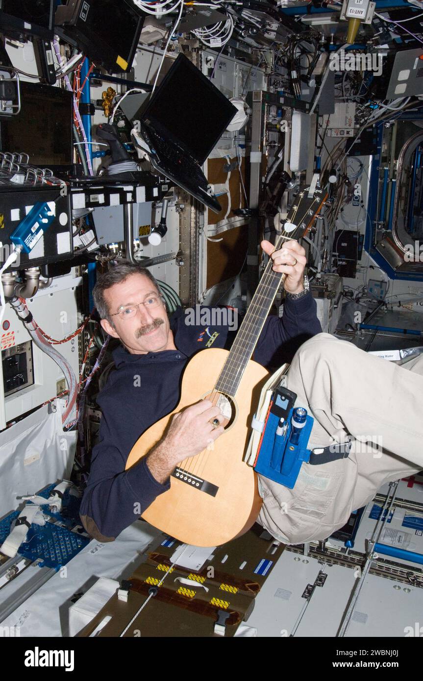 NASA astronaut and Expedition 30 commander Dan Burbank plays guitar in ...
