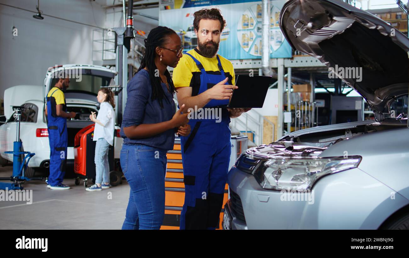 Mechanic in car service picks torque wrench from work station bench ...