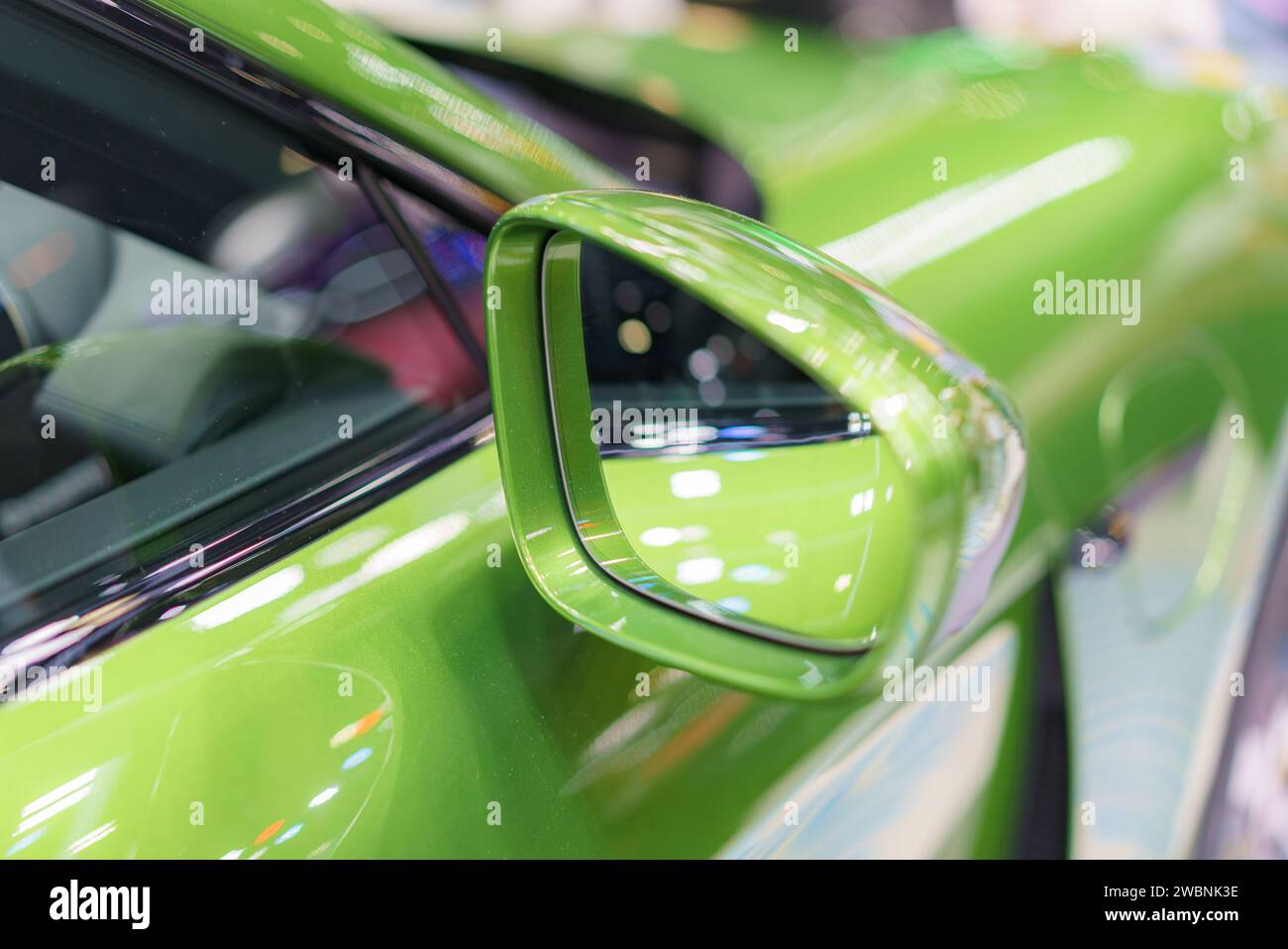 close-up shot showcasing the sleek blue side mirror of a modern car ...