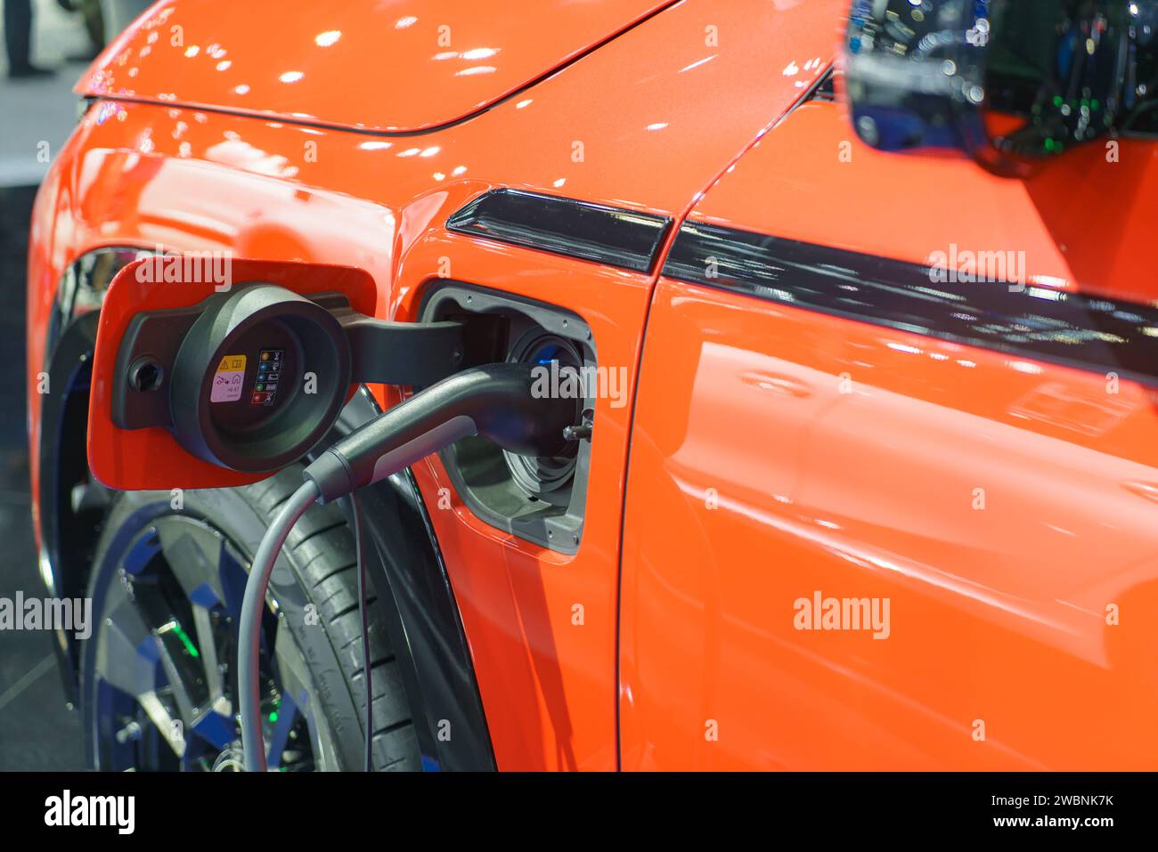 EV car at rest, connected to a charging station, embodying the ...