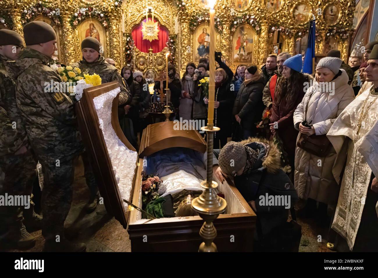 Kyiv, Ukraine. 11th Jan, 2024. A little girl mourns near the coffin of ...