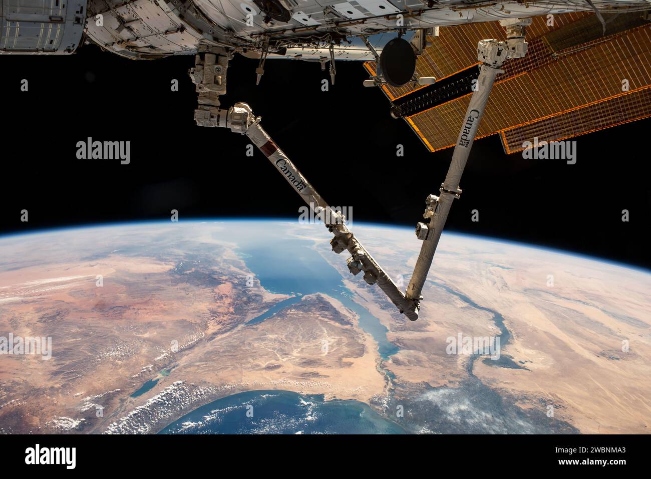 The Canadarm2 robotic arm extends from the ISS over Turkey, with the ...