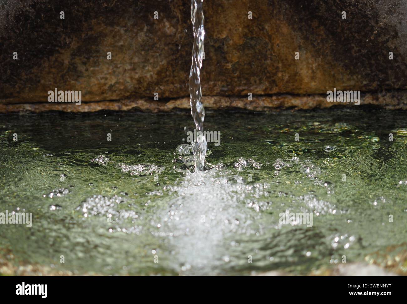 Water Jet Of An Ancient Stone Fountain Stock Photo - Alamy