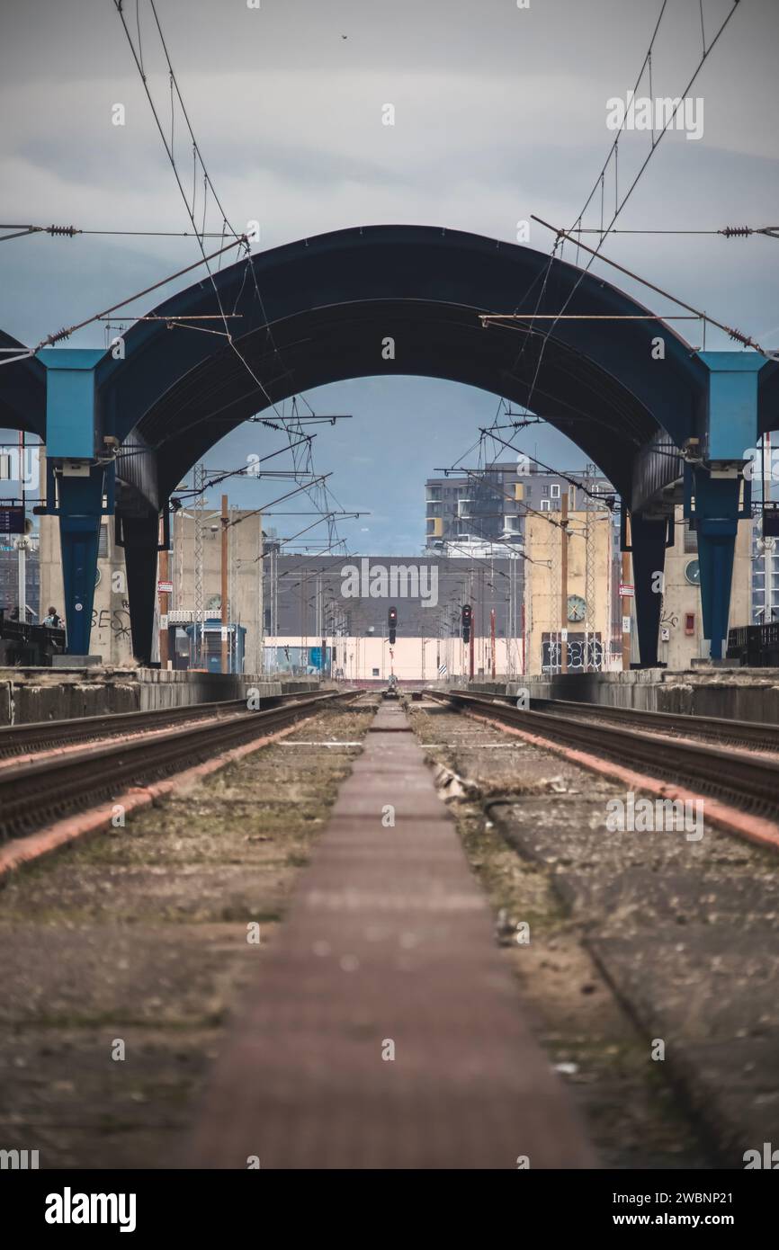 abandoned rusted train station with train tracks and wires during a ...