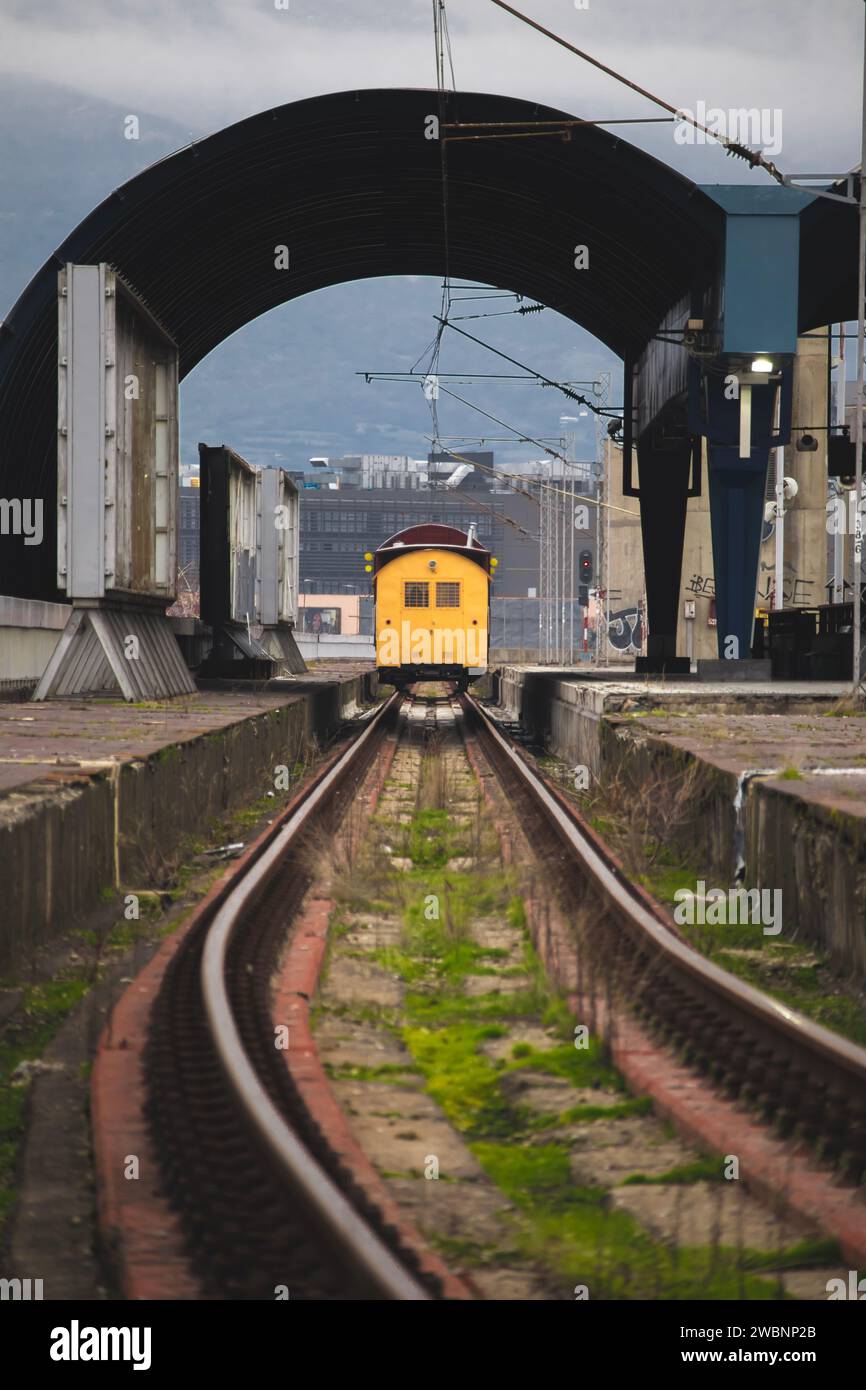 Abandoned train station with an old yellow wagon / train car and a ...