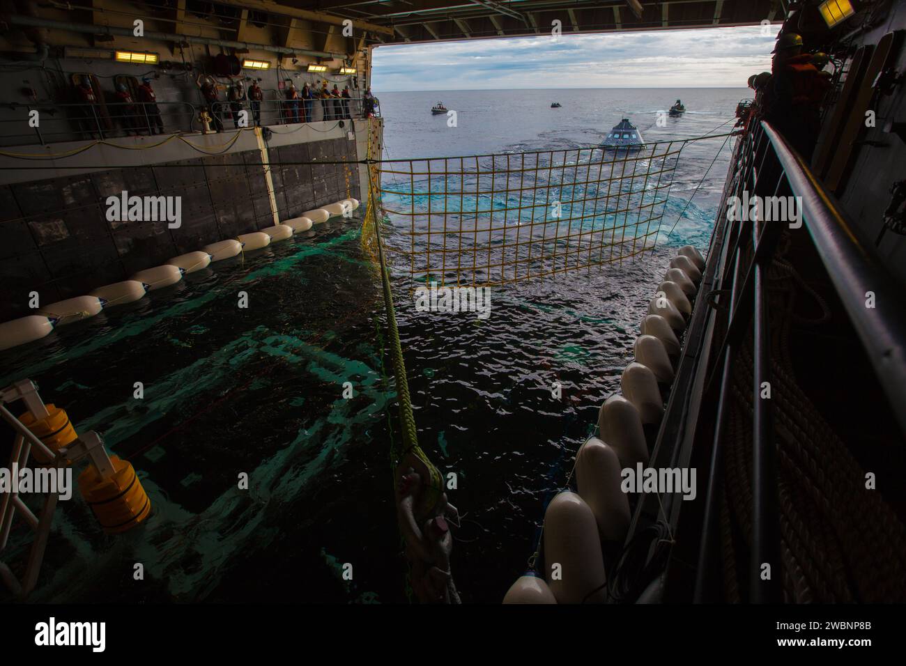 A test version of the Orion crew module is guided toward the flooded ...