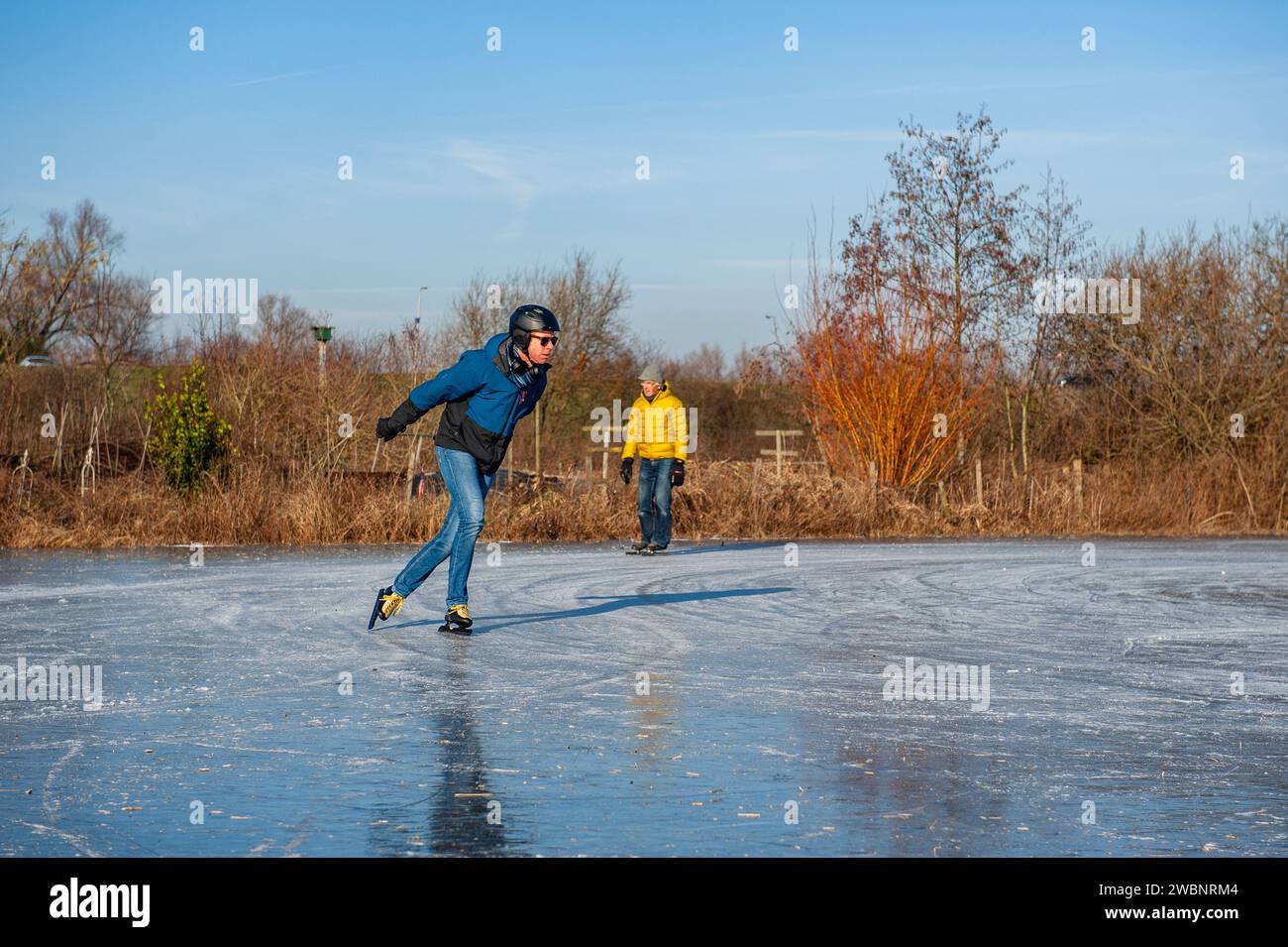 Nijmegen, Netherlands. 11th Jan, 2024. Two men are seen skating on ice ...