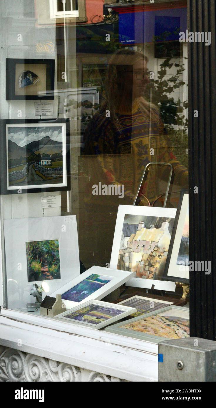 Window shopping in Brecon High Street: the shop windows are filled with ...
