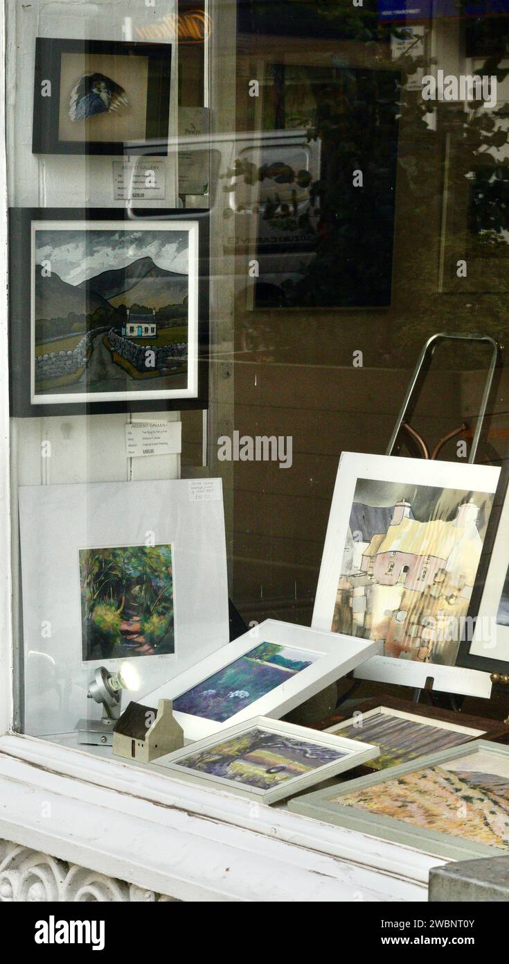 Window shopping in Brecon High Street: the shop windows are filled with ...