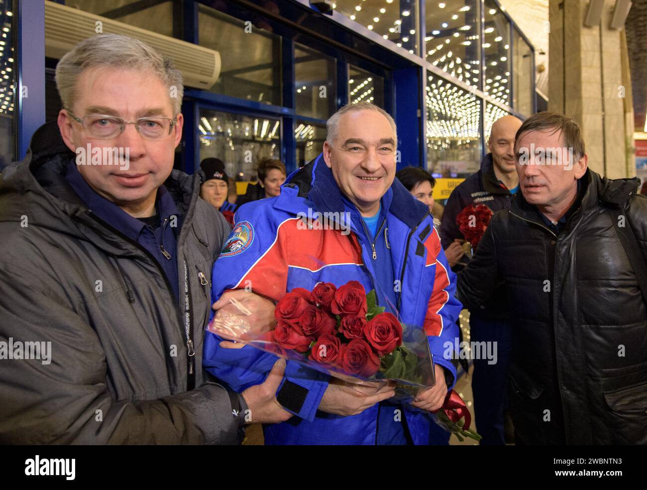 Roscosmos cosmonaut Alexander Skvortsov, center, is supported by Deputy Head of the Search-and ...