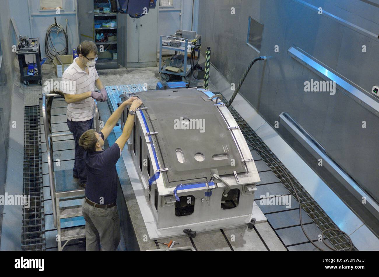 Technicians work on the composite crew module adapter (CMA) panels for ... Technicians work on the composite crew module adapter (CMA) panels for ...