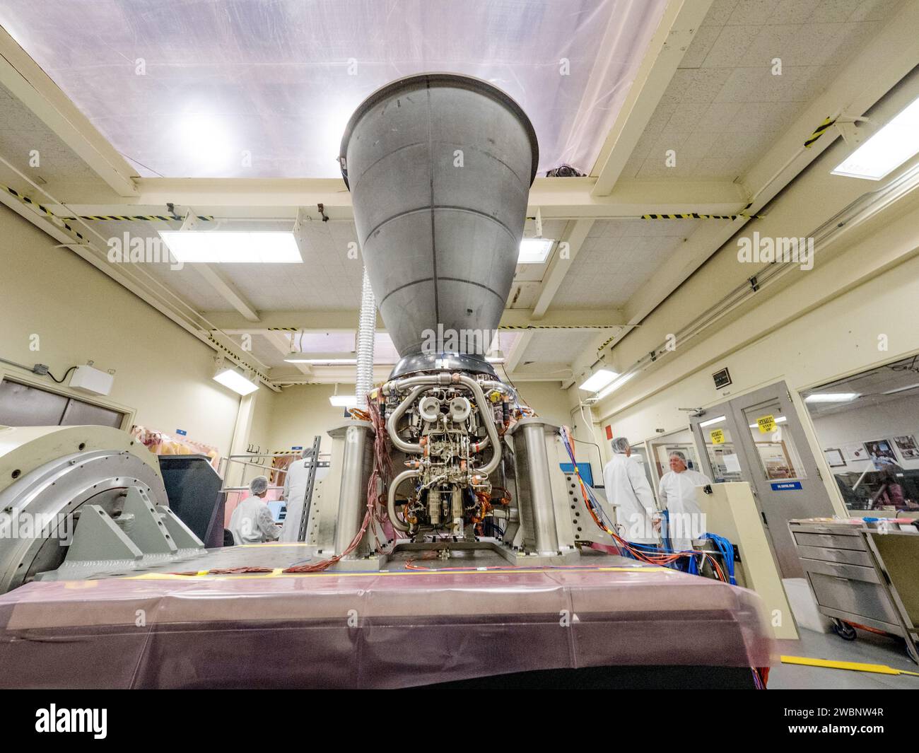 An Orbital Maneuvering System engine is vibration tested at NASA’s ...