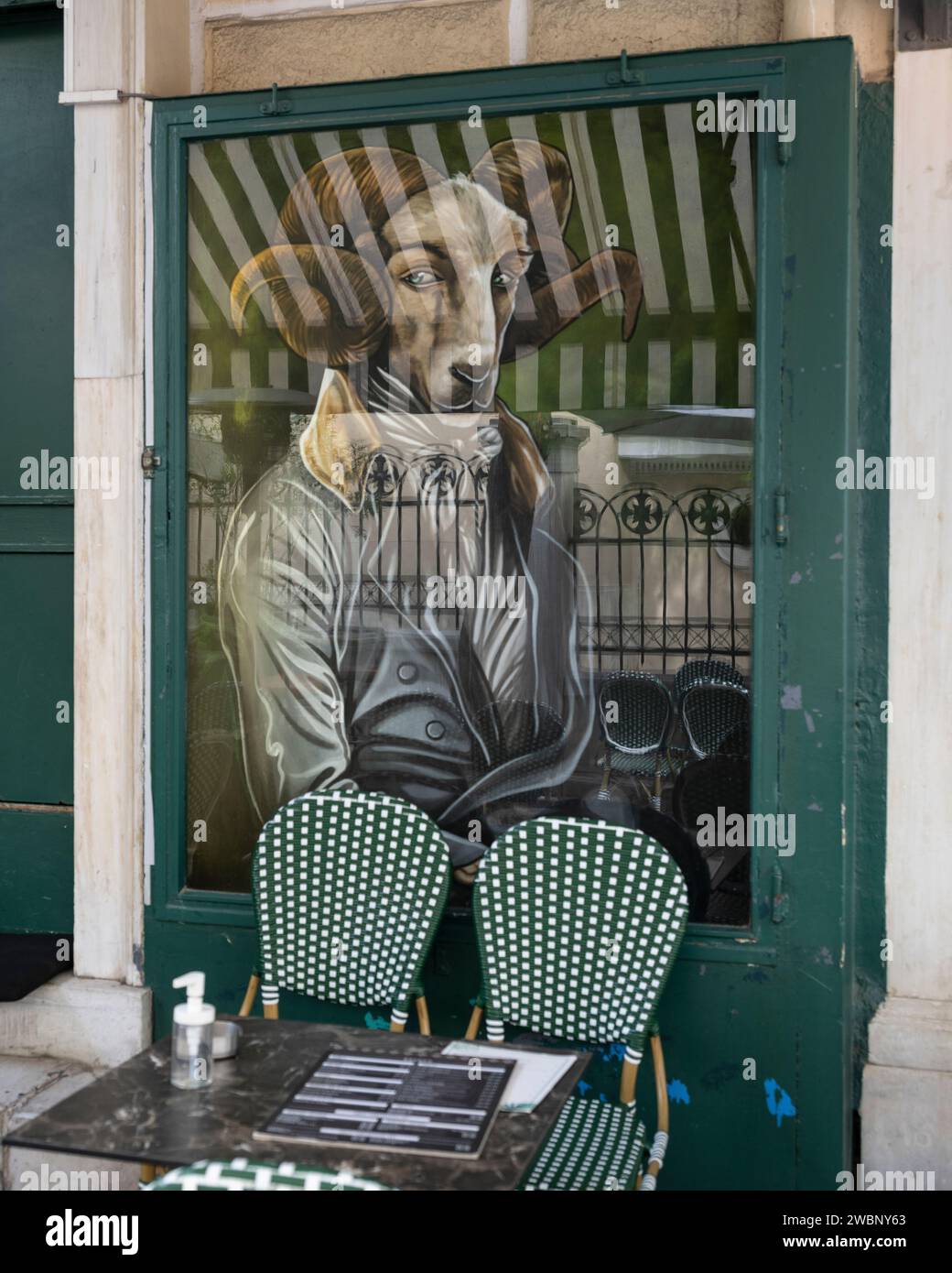 Reflection of a painting of a goat dressed in a suit in Athens Greece ...