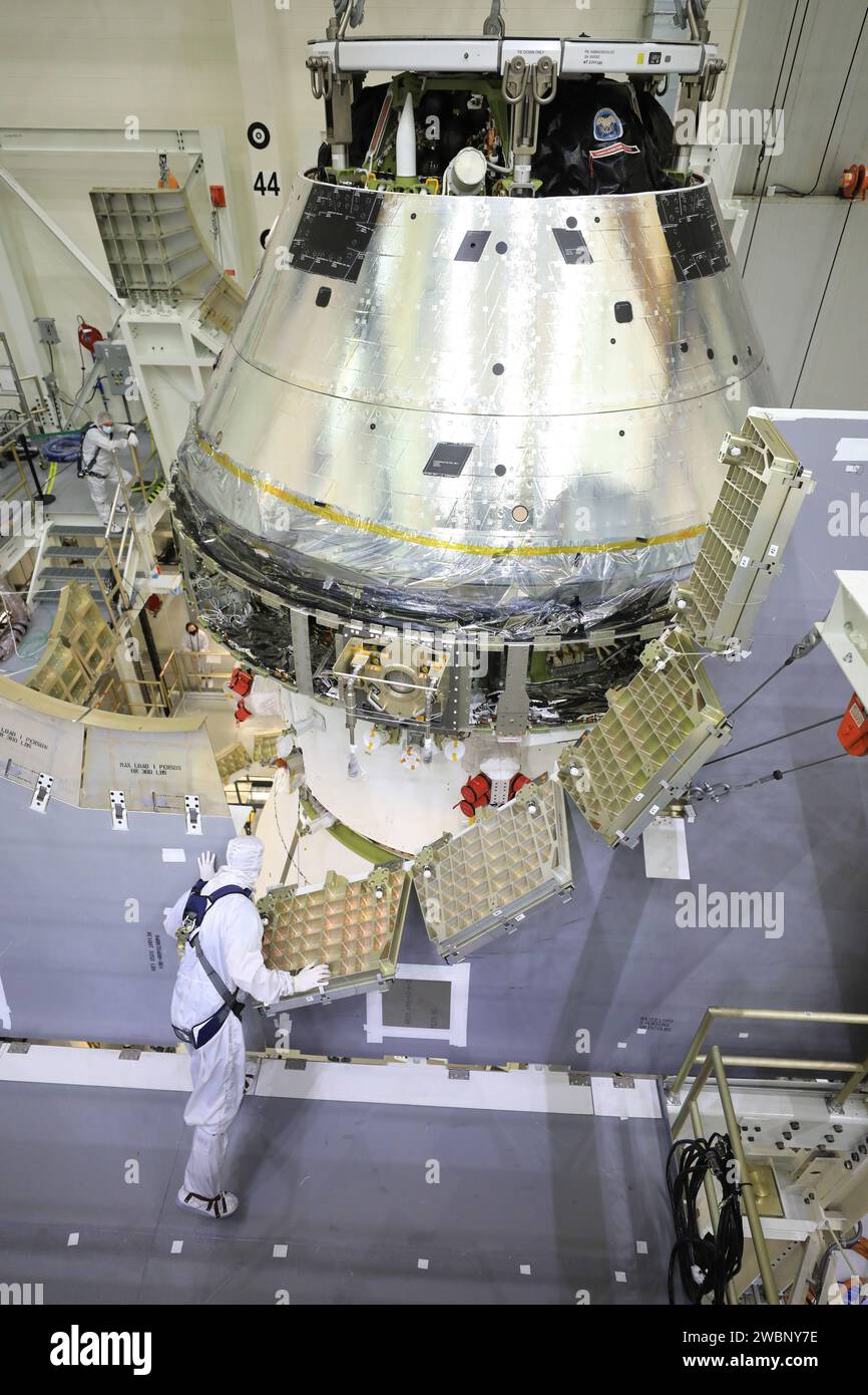 Technicians at NASA’s Kennedy Space Center in Florida work to safely ...