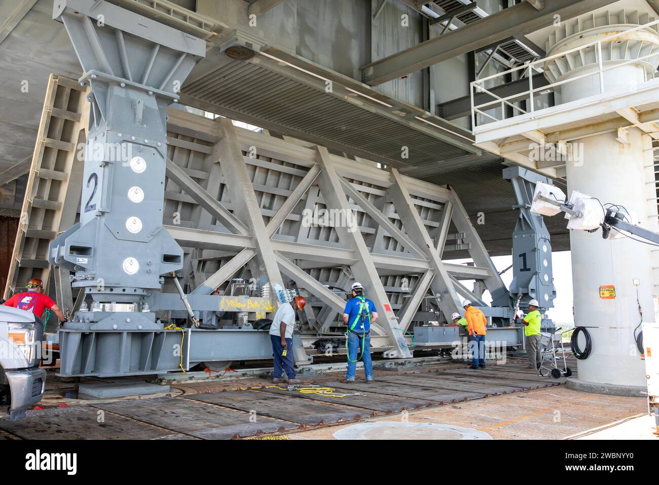 Special ground support equipment is used to position one of two side ...