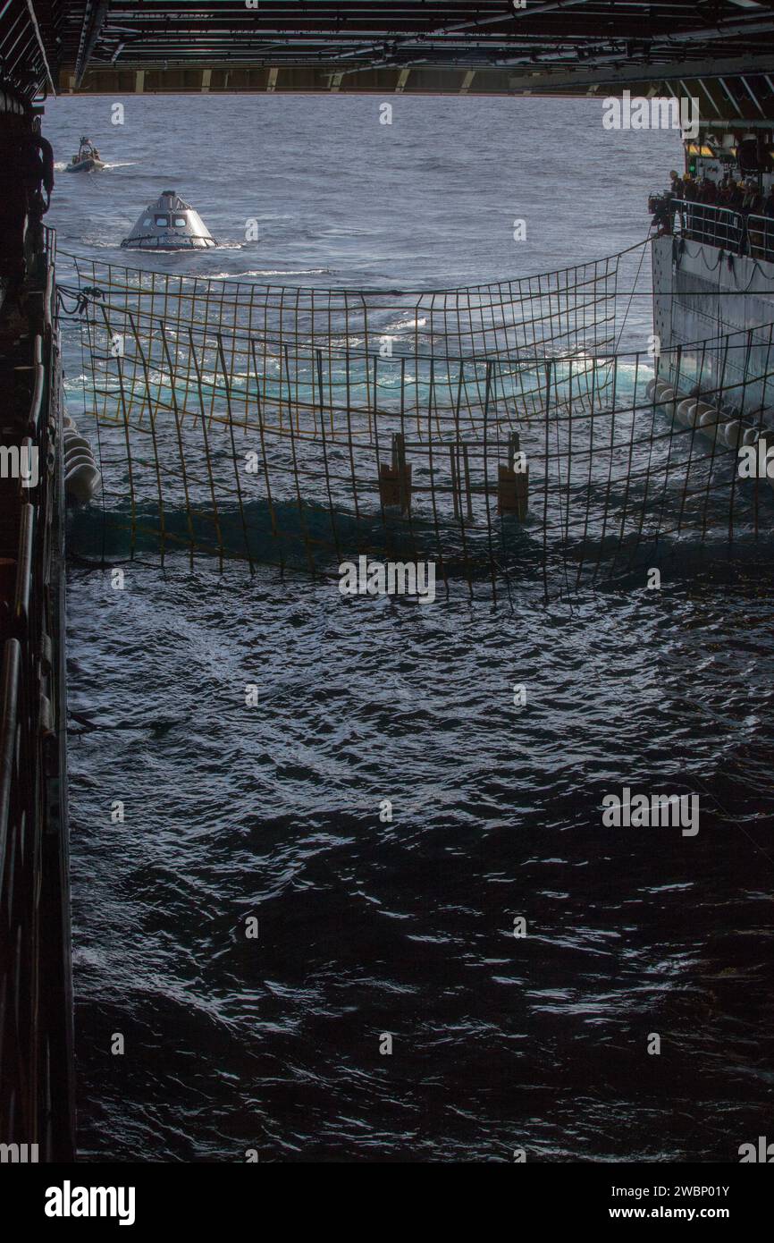 A test version of the Orion crew module floats outside the well deck of ...