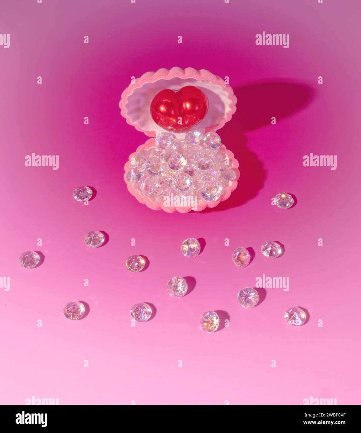 A Velvet Pink Clam Filled with Diamonds and Red Hearts on a Pastel Pink ...