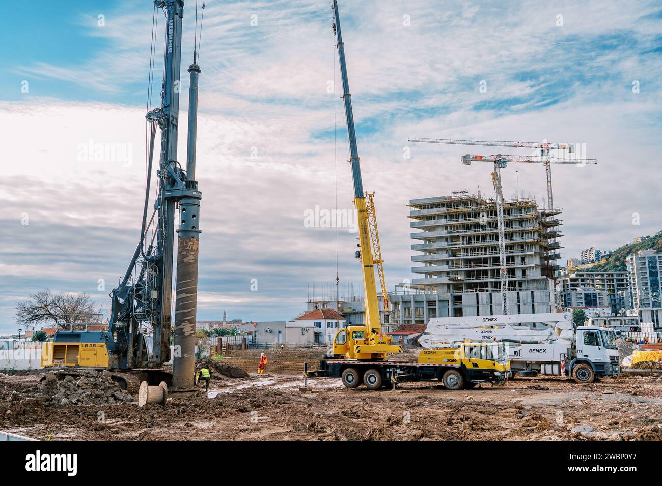 Drilling machines install piles at a construction site near high-rise ...