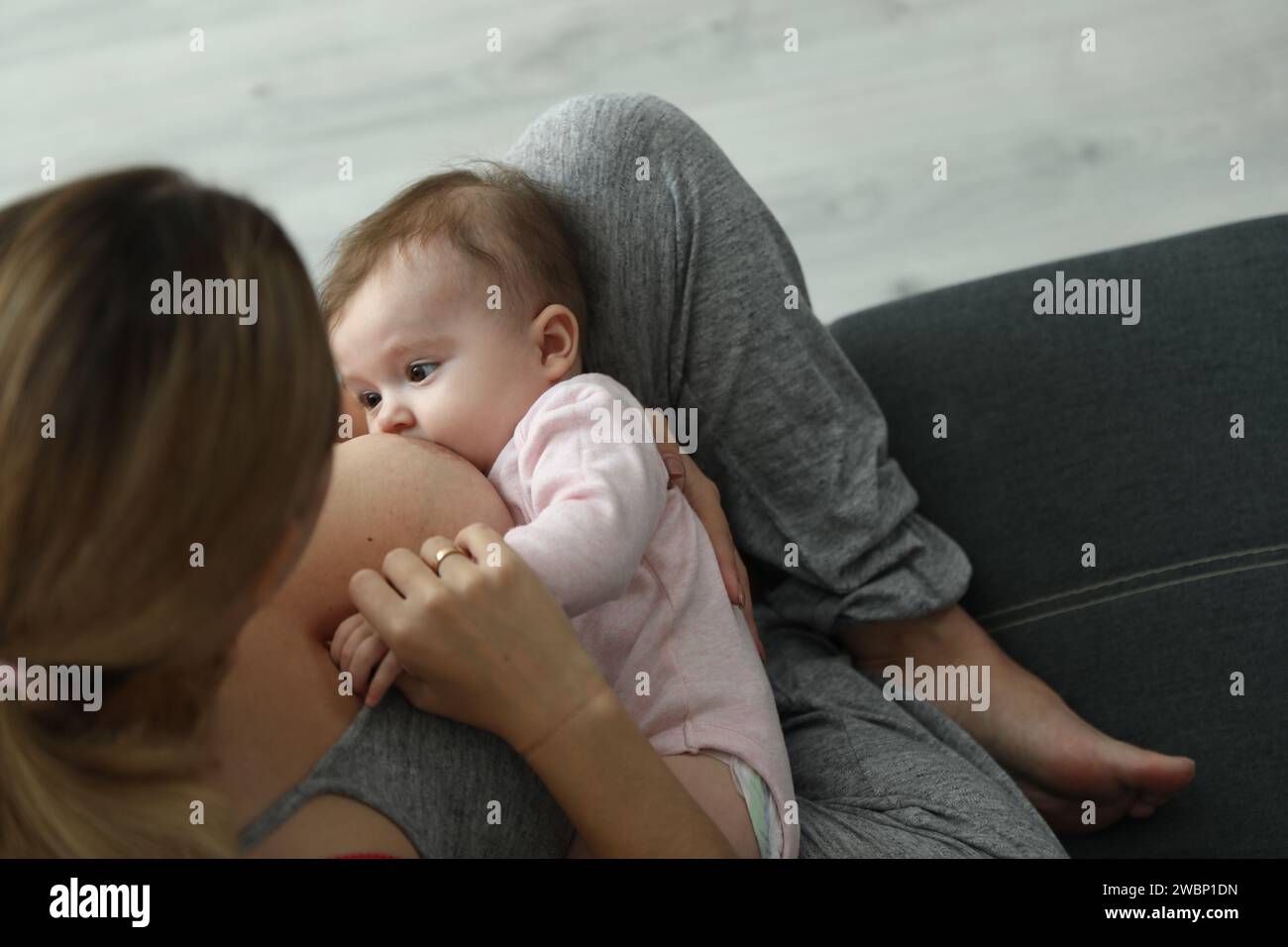 Young woman breastfeeding her baby at home, closeup Stock Photo - Alamy