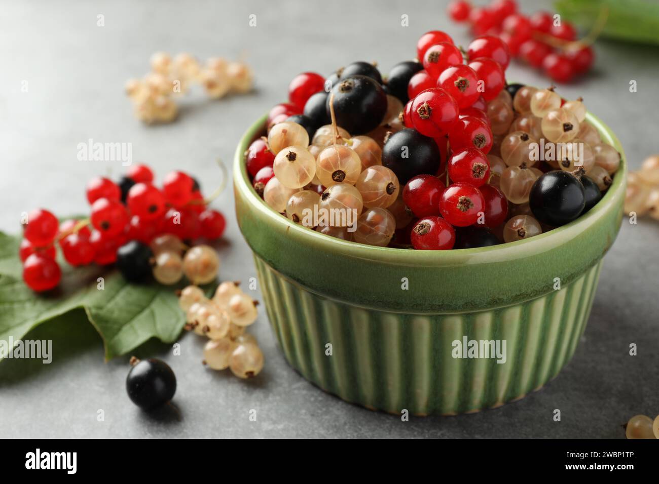 Different fresh ripe currants on light grey table, closeup Stock Photo ...