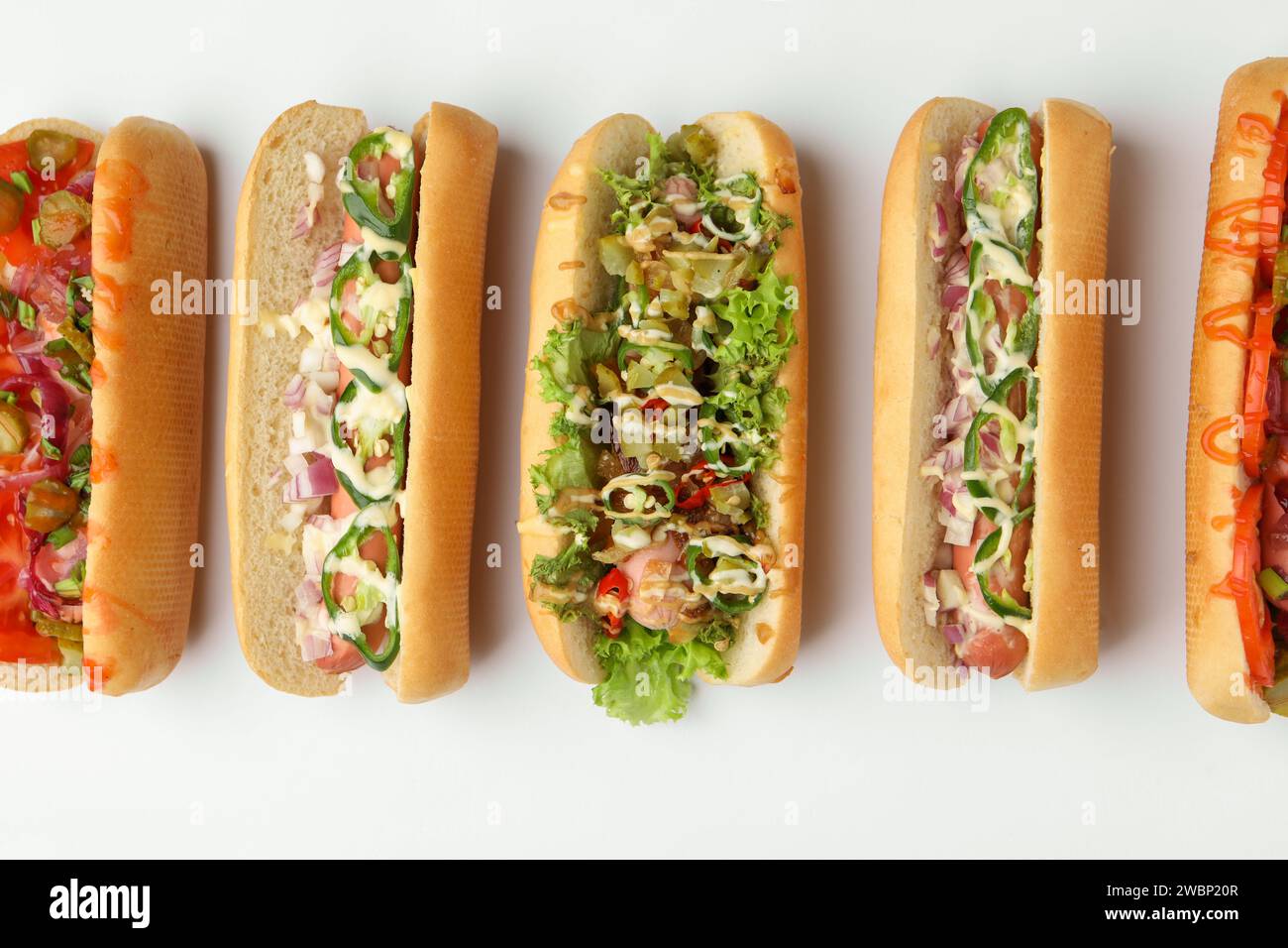 Delicious hot dogs with different toppings on white background, flat ...