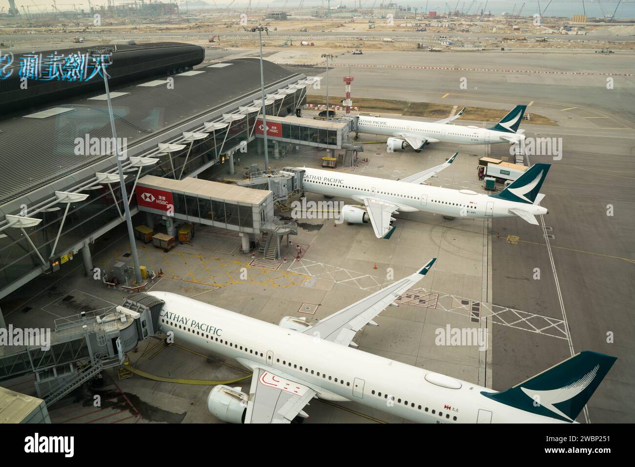 aircrafts and airport buildings on airside apron at Hong Kong ...