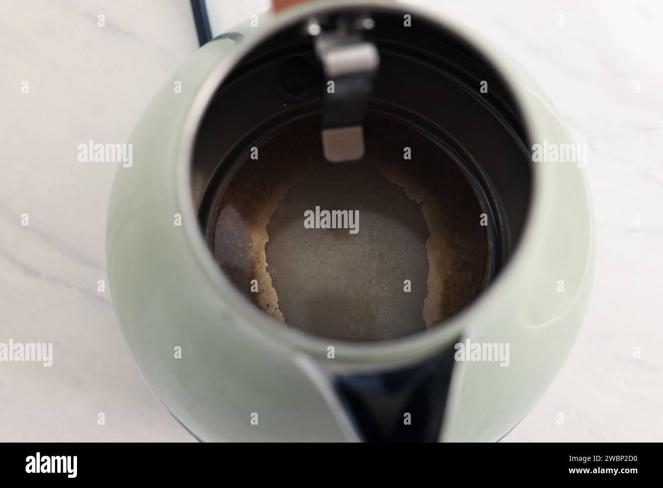 Electric kettle with limescale on table, above view Stock Photo - Alamy