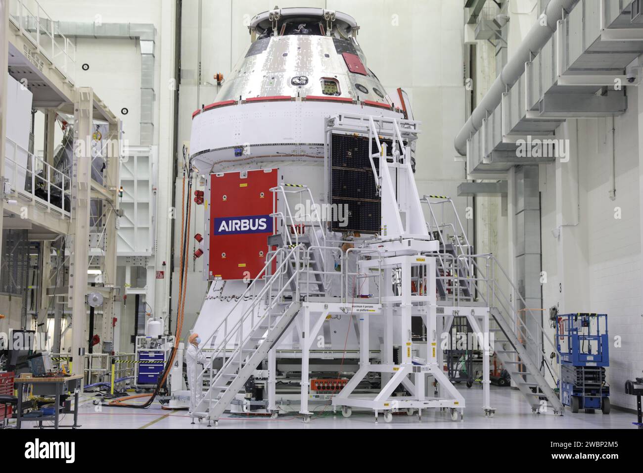 The final of four solar array wings is shown being installed prior to ...