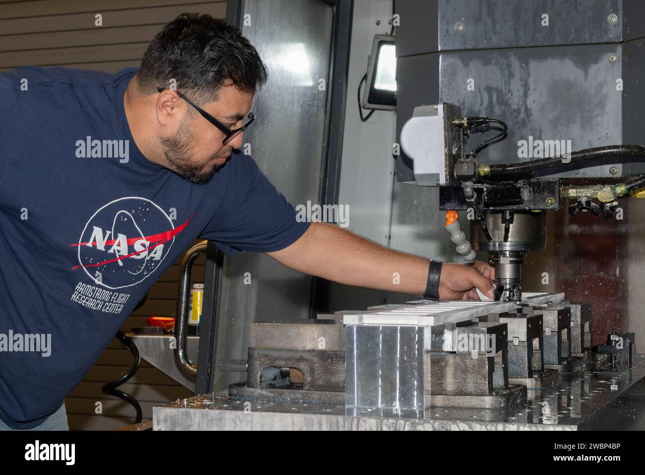 German Escobar works on milling the strut frame assembly for a 10-foot ...