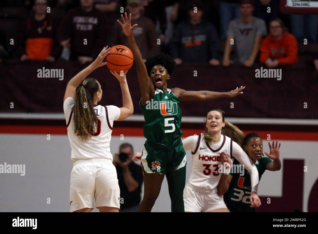 Virginia Tech's Olivia Summiel (20) shoots while defended by Miami's ...