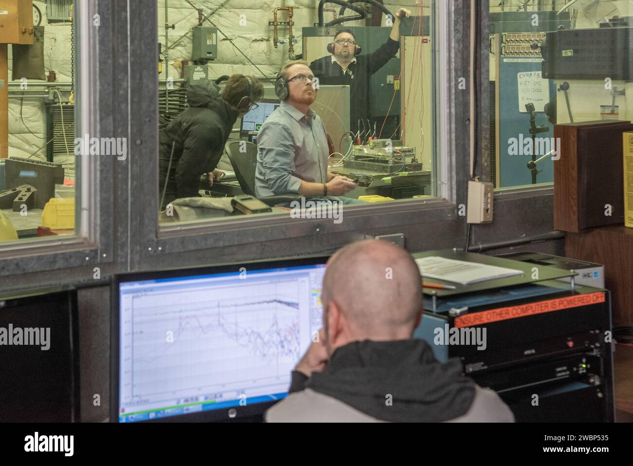 Engineers monitor data during vibration testing of a cruise motor ...