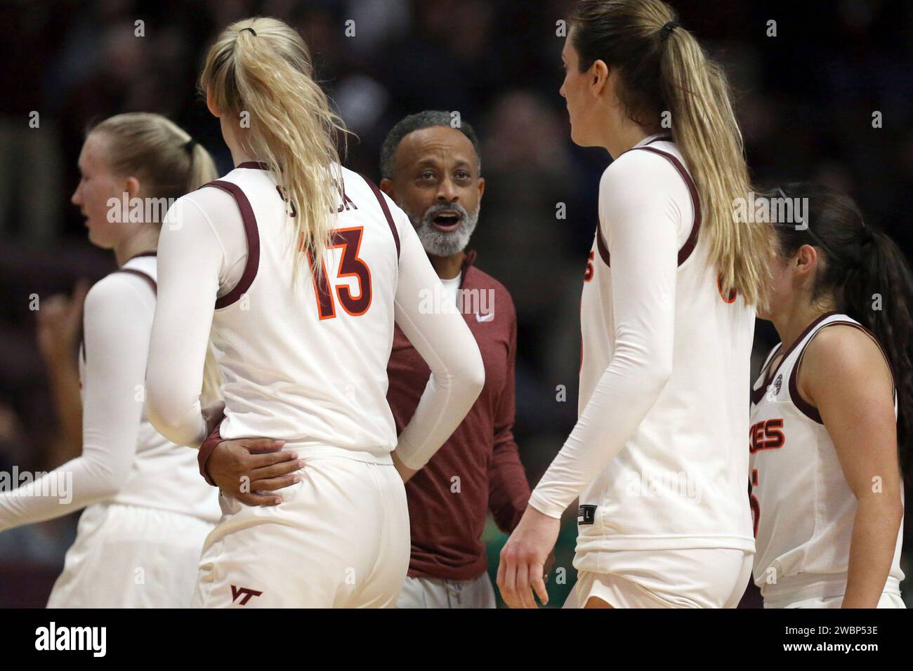Virginia Tech coach Kenny Brooks talks with Clara Strack (13) and ...