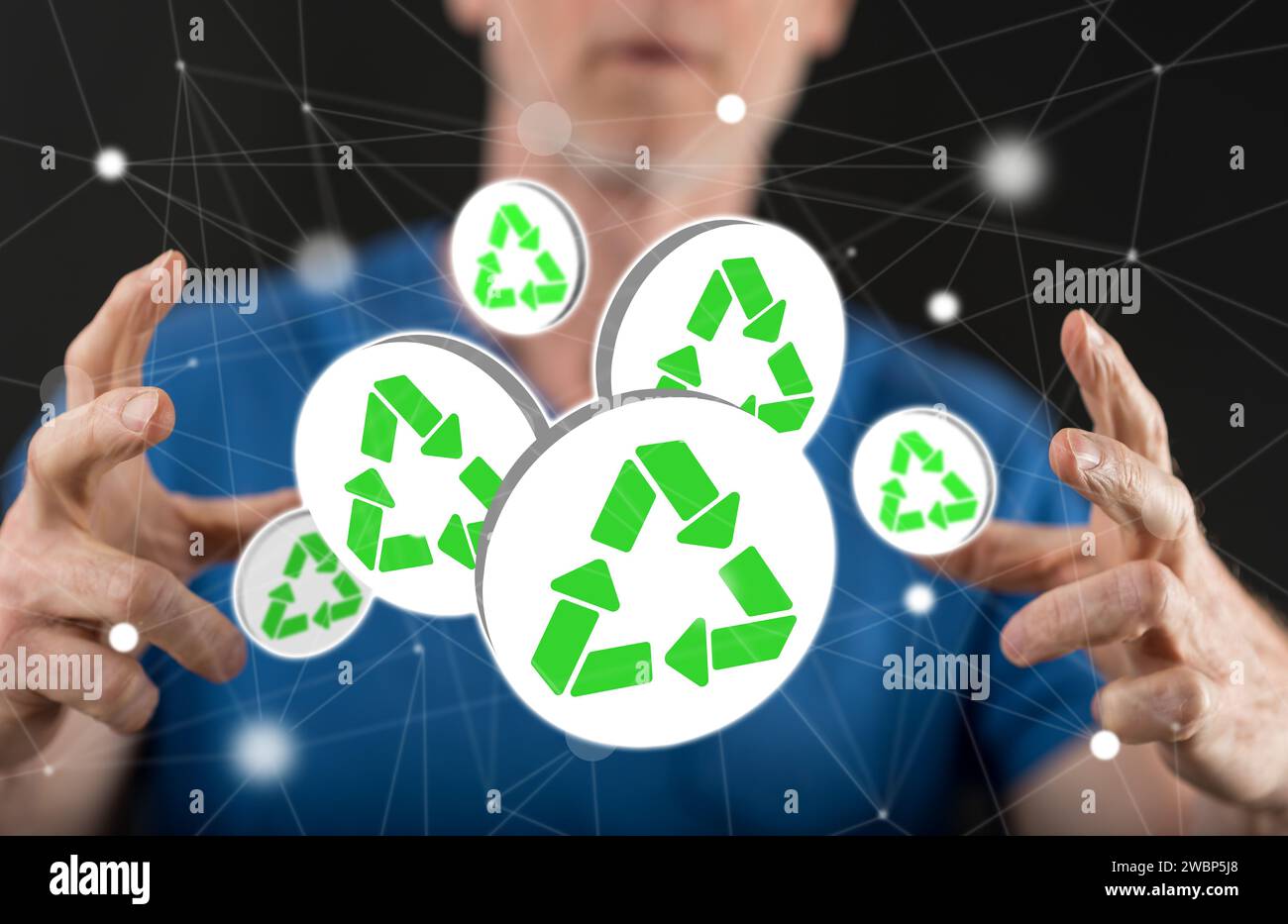 Recycling concept between hands of a man in background Stock Photo - Alamy