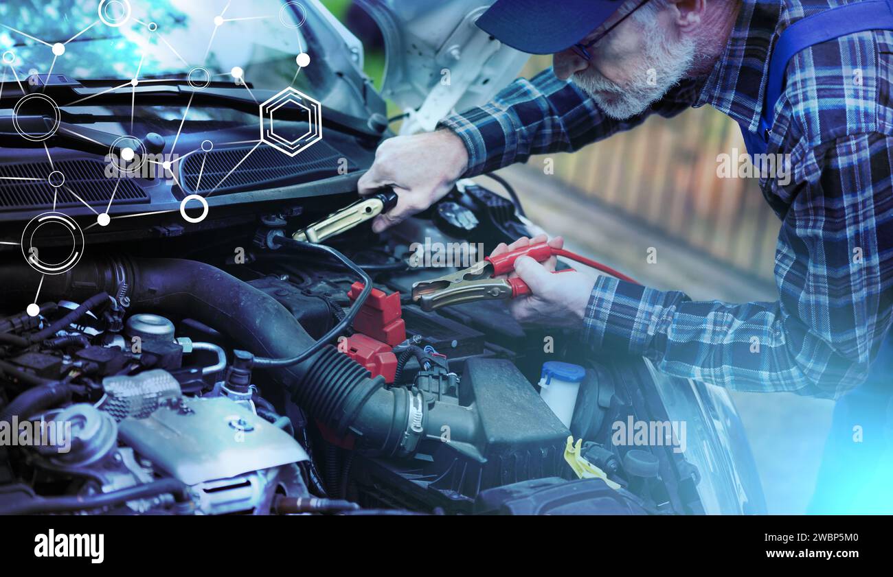 Car mechanic using cables to start a car engine; light effect Stock ...