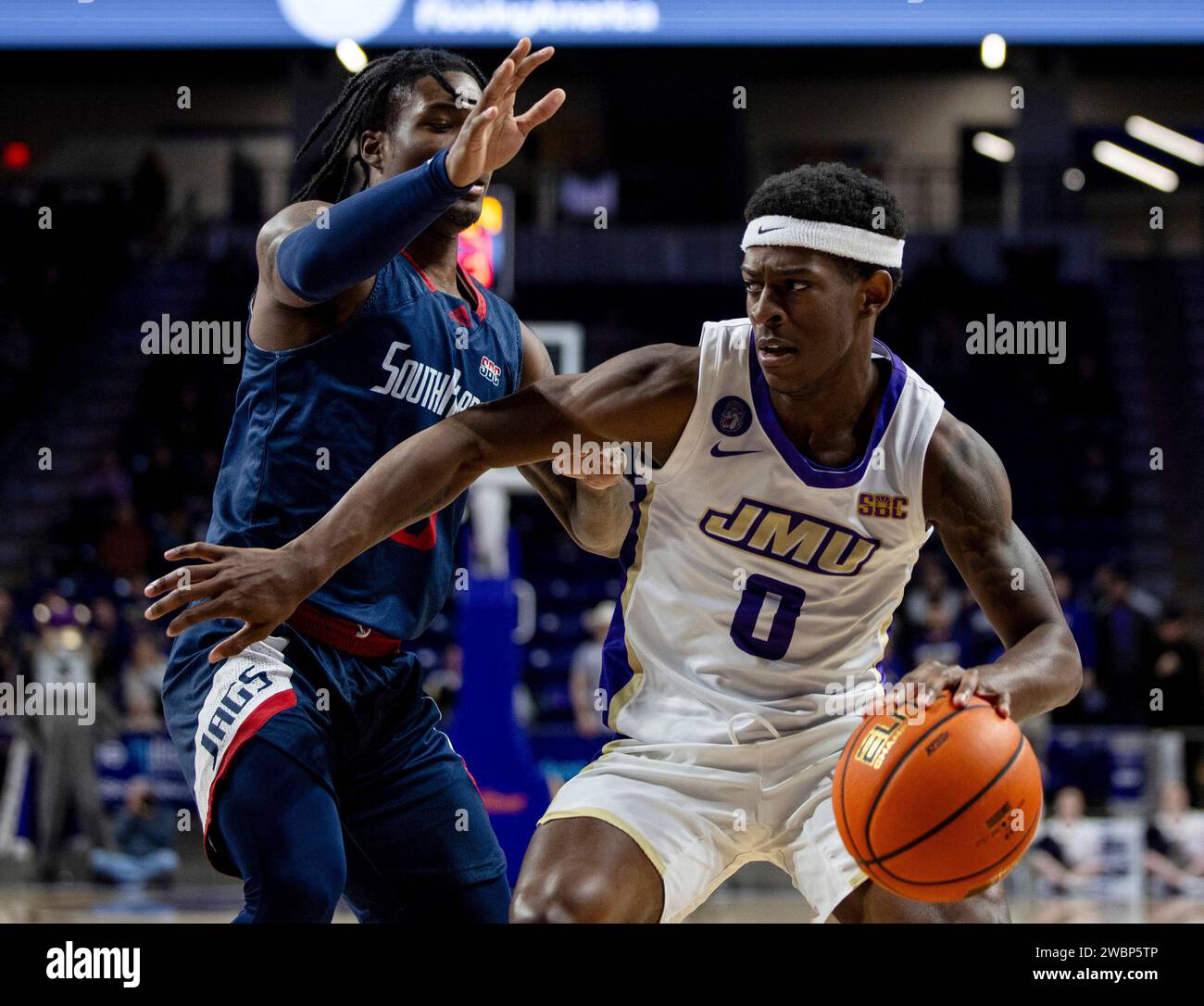 James Madison guard Xavier Brown (0) drives against South Alabama guard ...