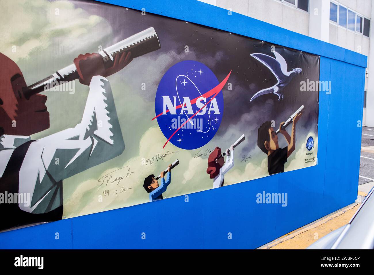 A large mural is on the wall in the hallway leading to the exit where ...