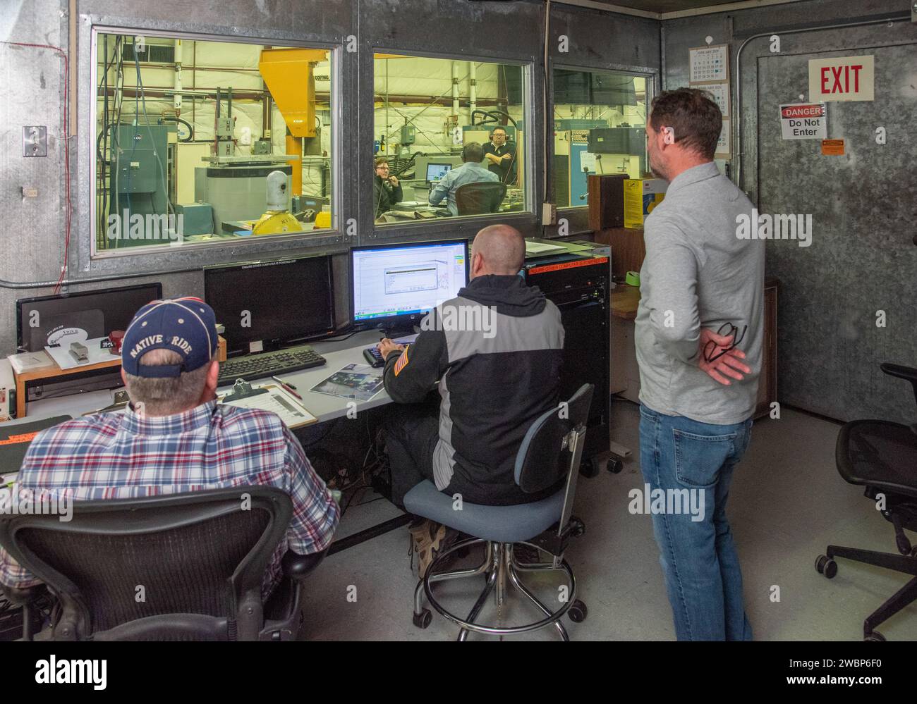 Engineers monitor data during vibration testing of a cruise motor ...