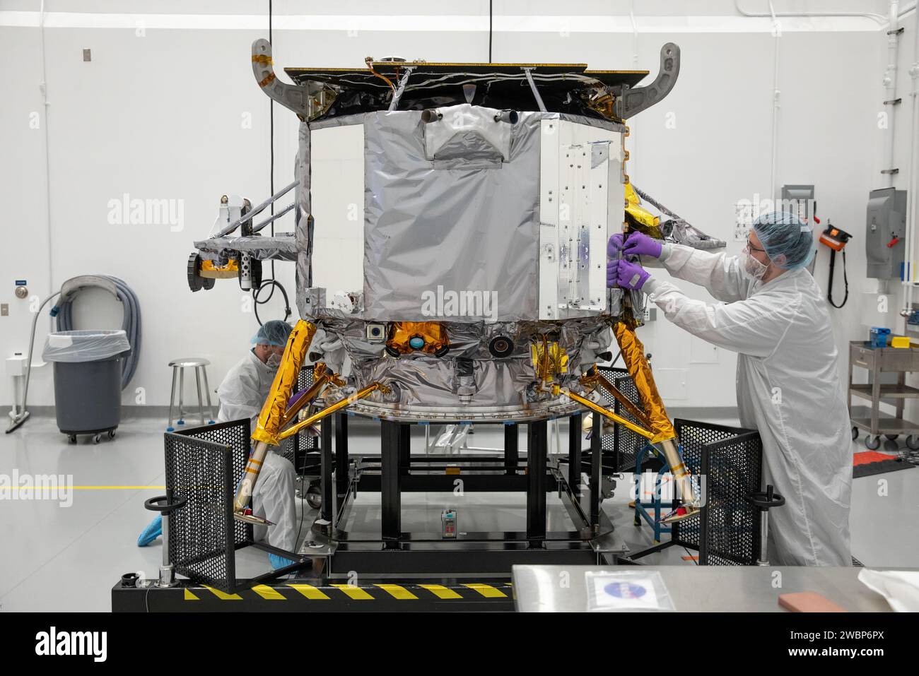 Teams with Astrobotic install the NASA meatball decal on Astrobotic’s Peregrine lunar lander on ...